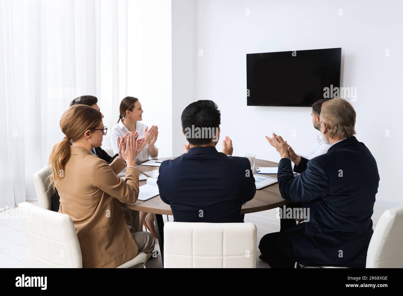 Business conference. Group of people watching presentation on tv screen ...