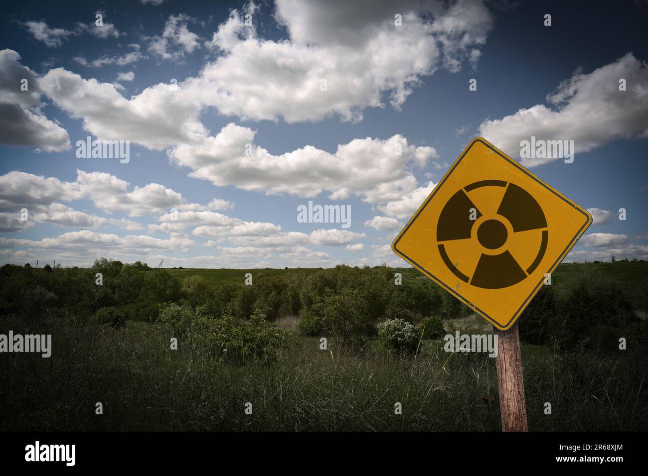 Radioactive pollution. Yellow warning sign with hazard symbol near ...