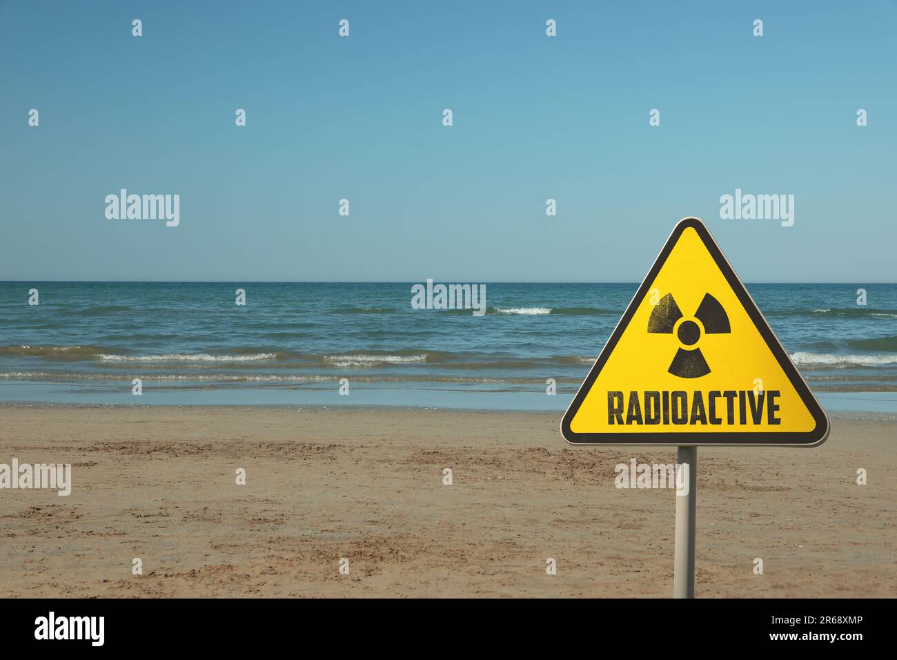 Radioactive pollution. Yellow warning sign with hazard symbol near ...