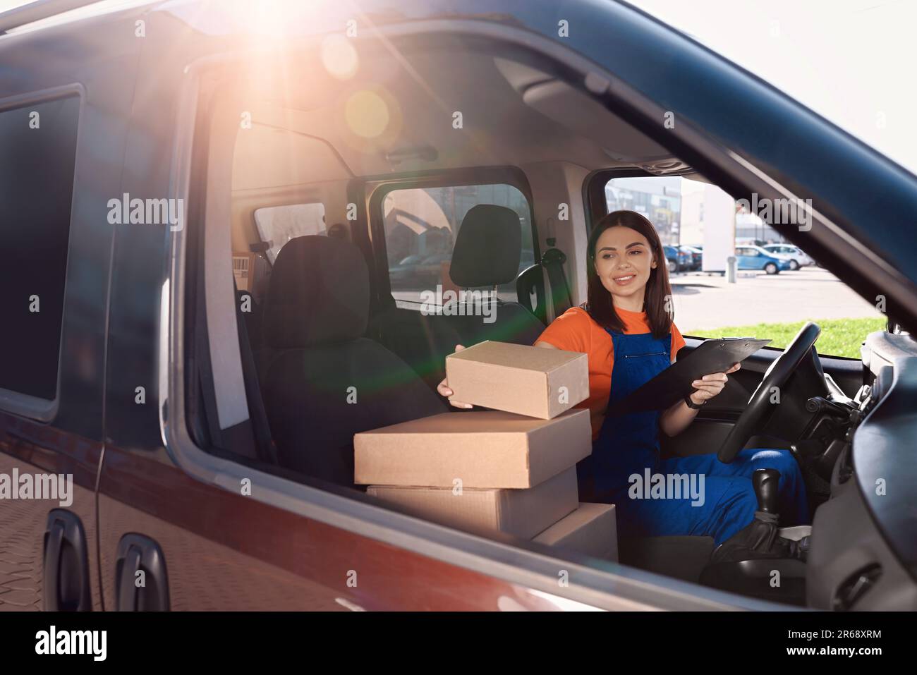 Female courier checking packages hi-res stock photography and images ...