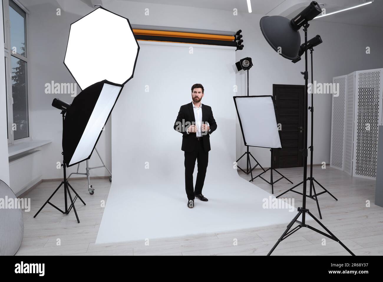 Handsome model posing in modern studio. Professional photo session ...
