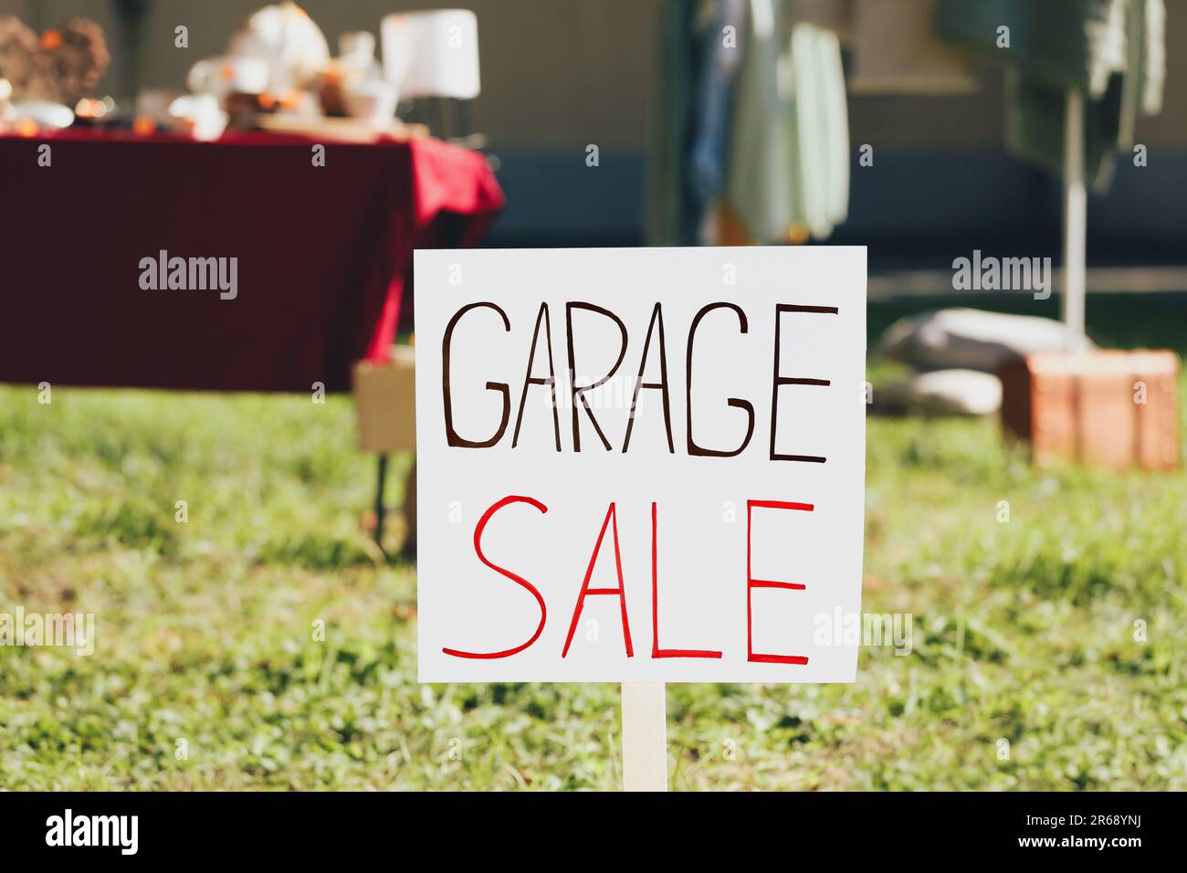 Sign Garage sale written on cardboard in yard, closeup Stock Photo - Alamy