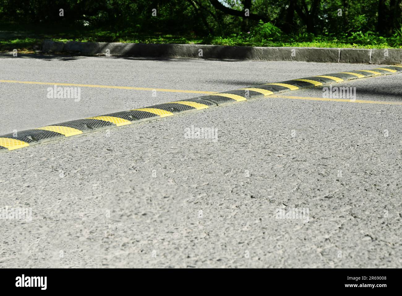 Speed bump on empty asphalt road. Traffic calming Stock Photo - Alamy