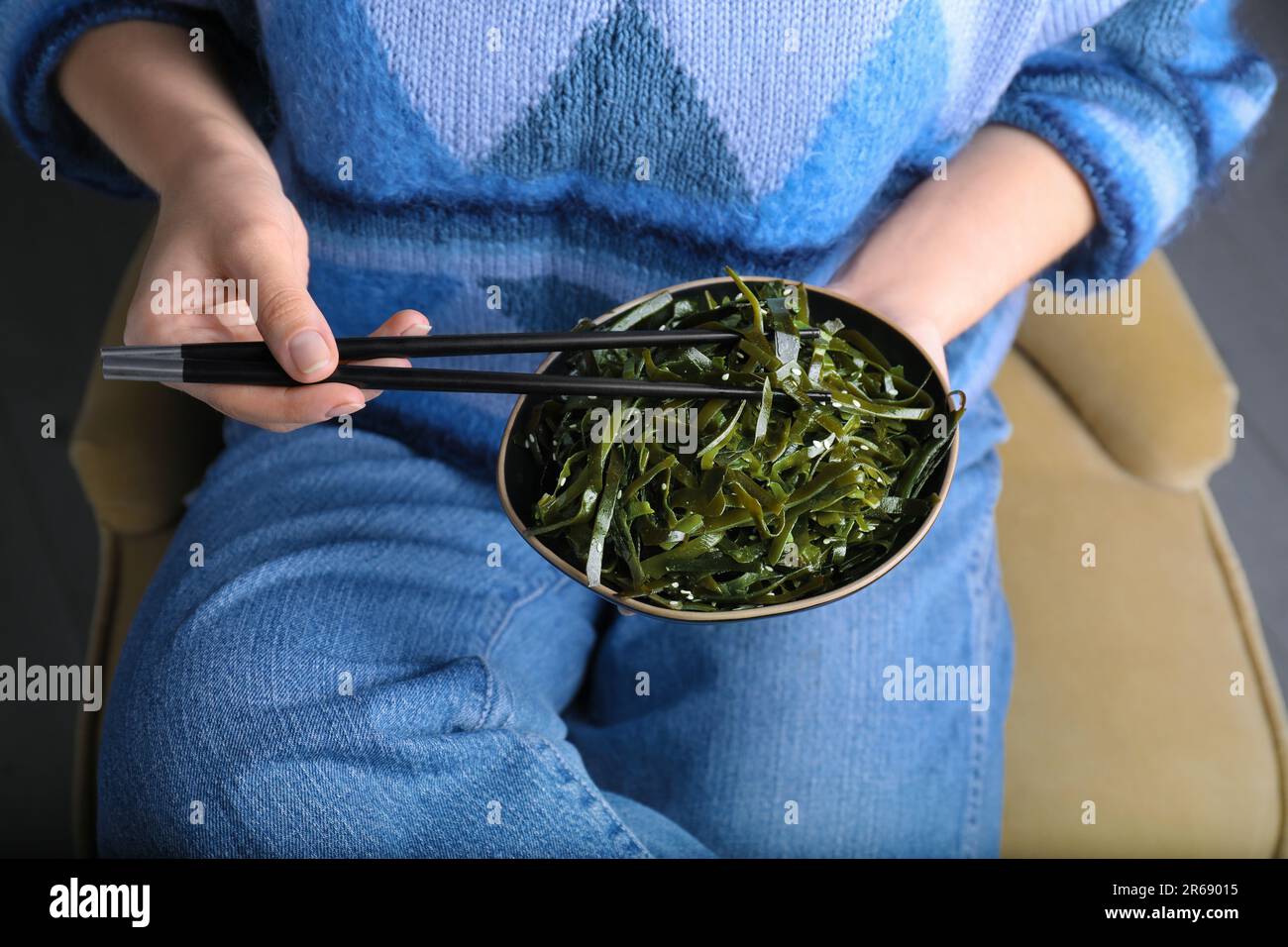 Woman eating fresh laminaria (kelp) seaweed, closeup Stock Photo - Alamy