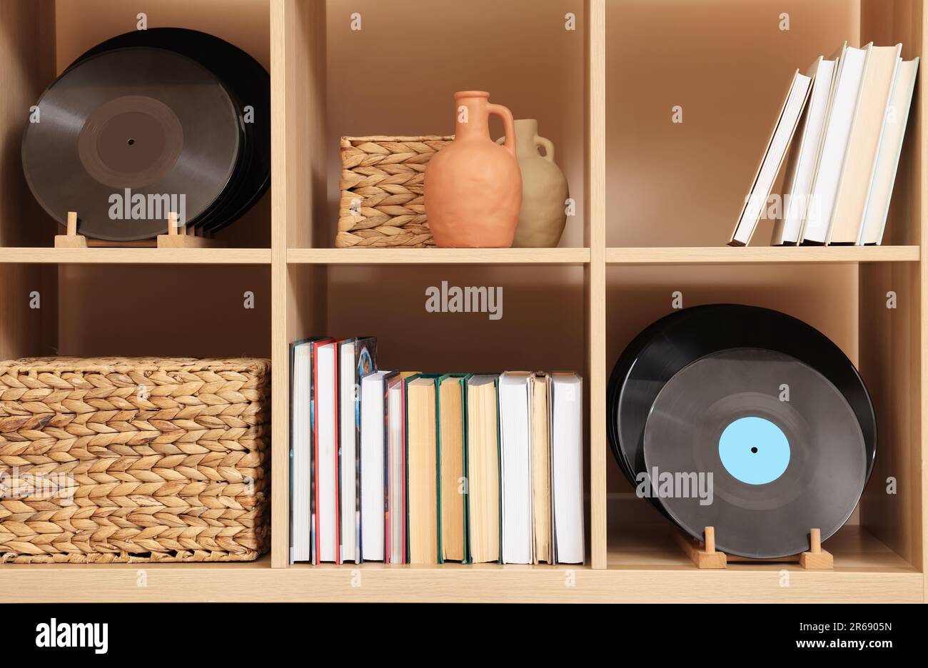 Wooden shelving unit with vinyl records near beige wall indoors Stock ...
