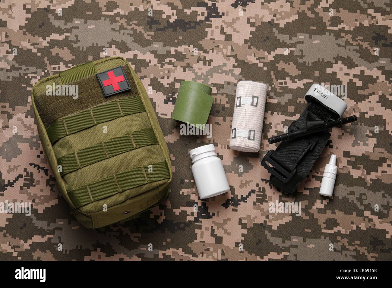 First aid kit with medical tourniquet, pills and bands on military ...