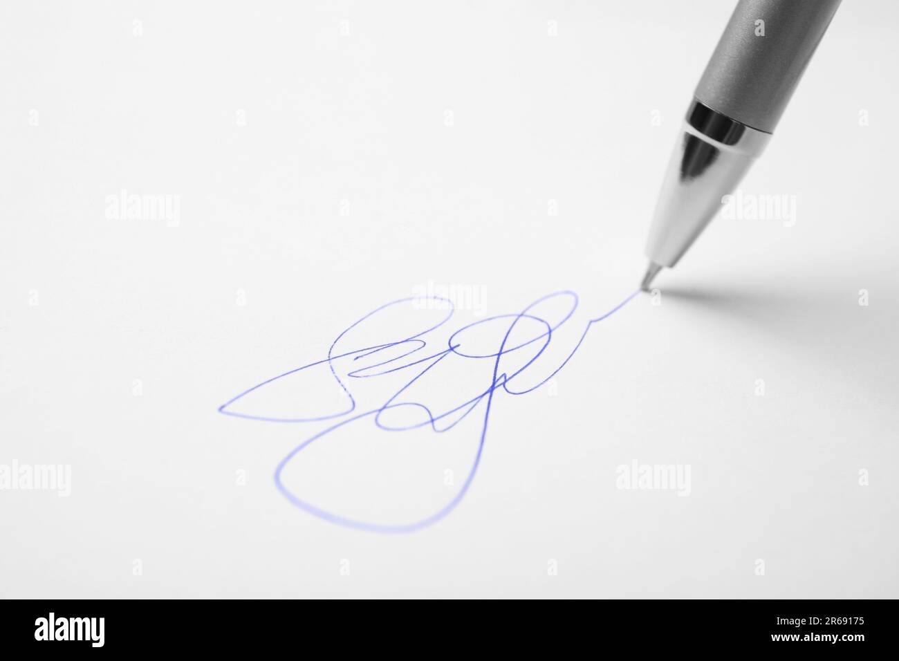 Signing on sheet of white paper with pen, closeup Stock Photo - Alamy