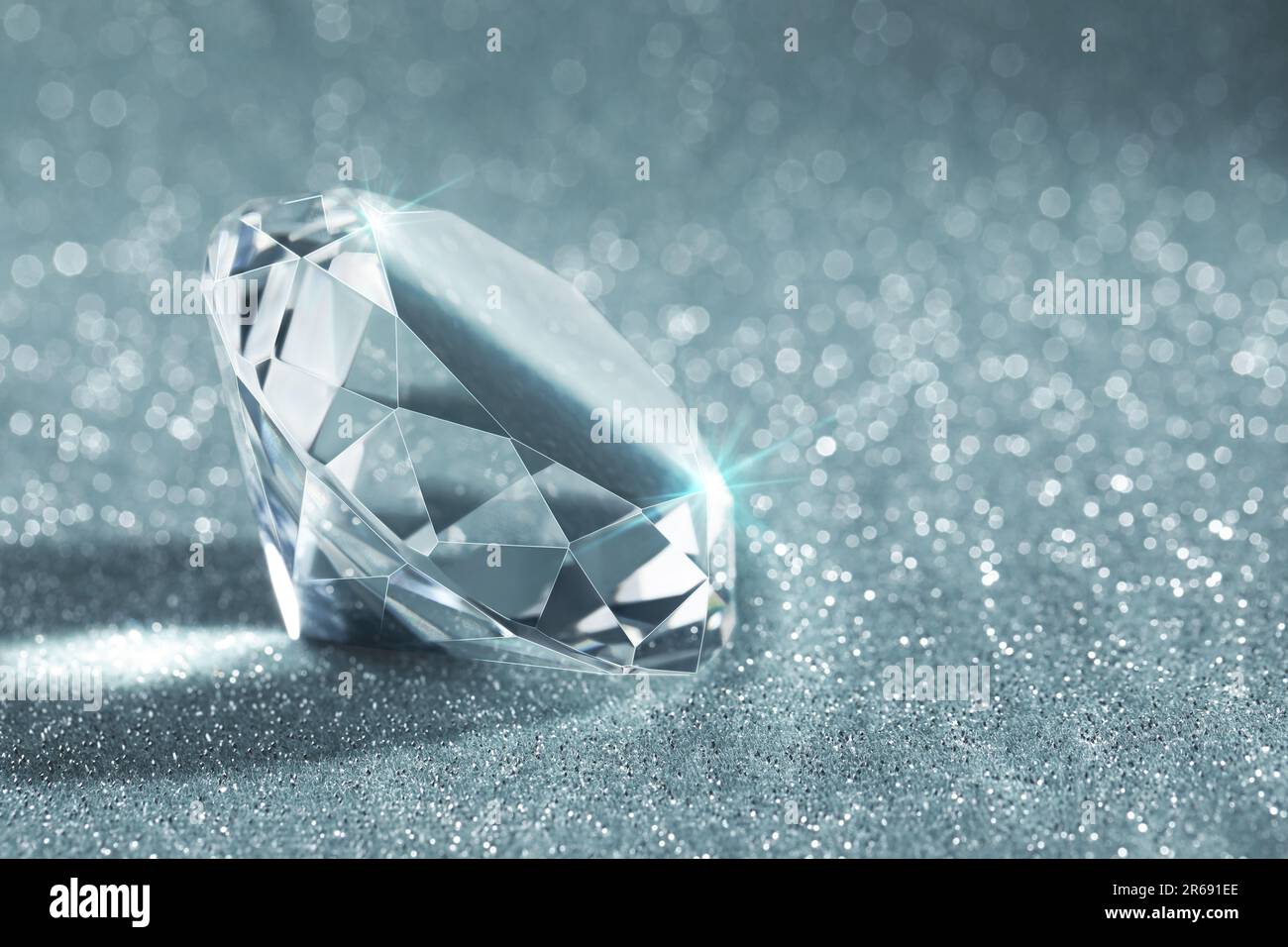 Beautiful shiny diamond on glitter background, closeup. Space for text ...