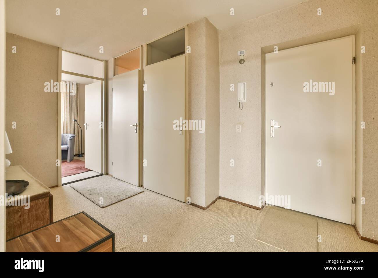 a hotel room with two doors and a mirror on the wall in front of the ...