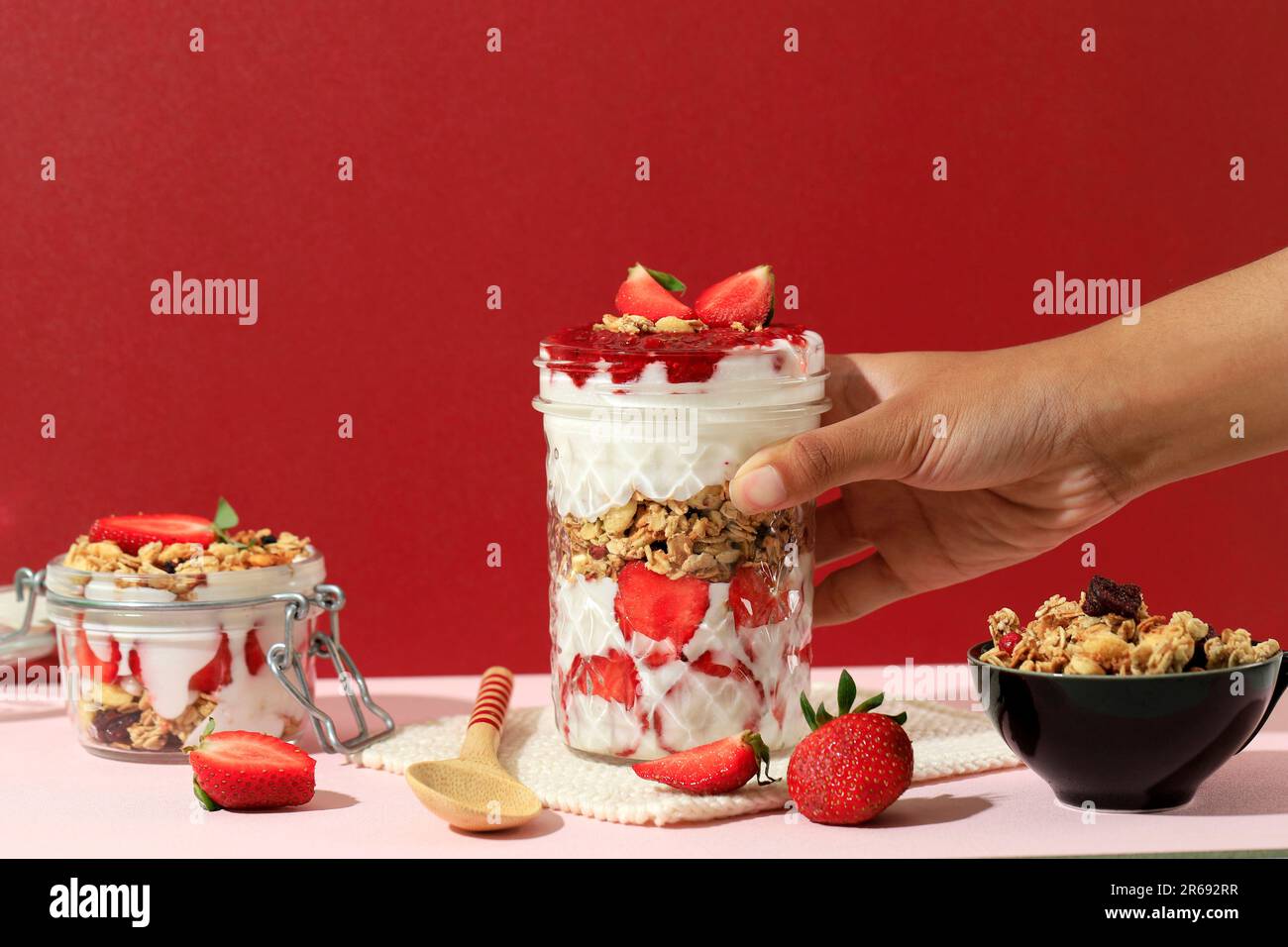 Female Hand Hold Drinking Jar with Strawberry Greek Yoghurt Parfait ...