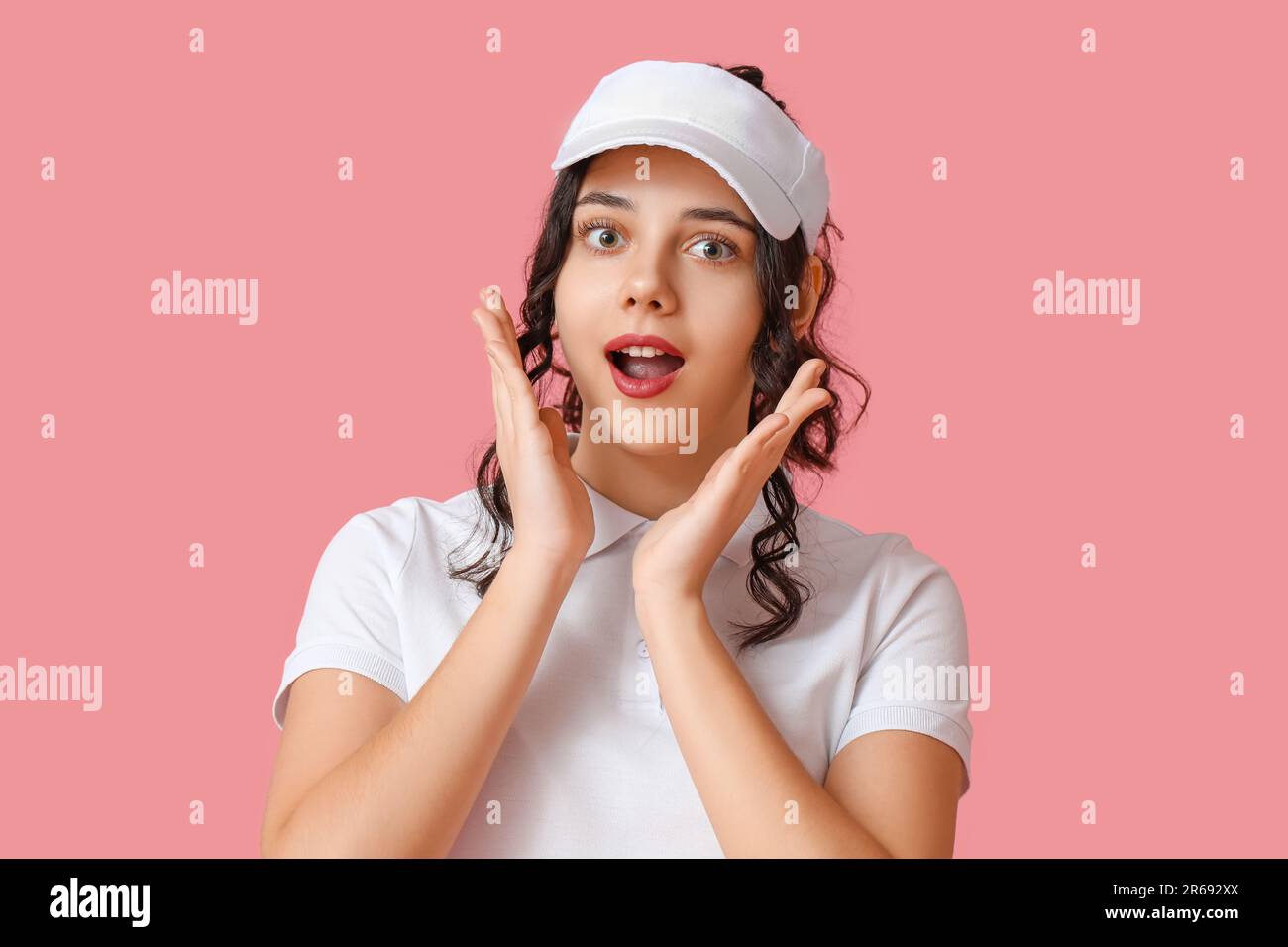 Surprised teenage tennis player on pink background, closeup Stock Photo ...