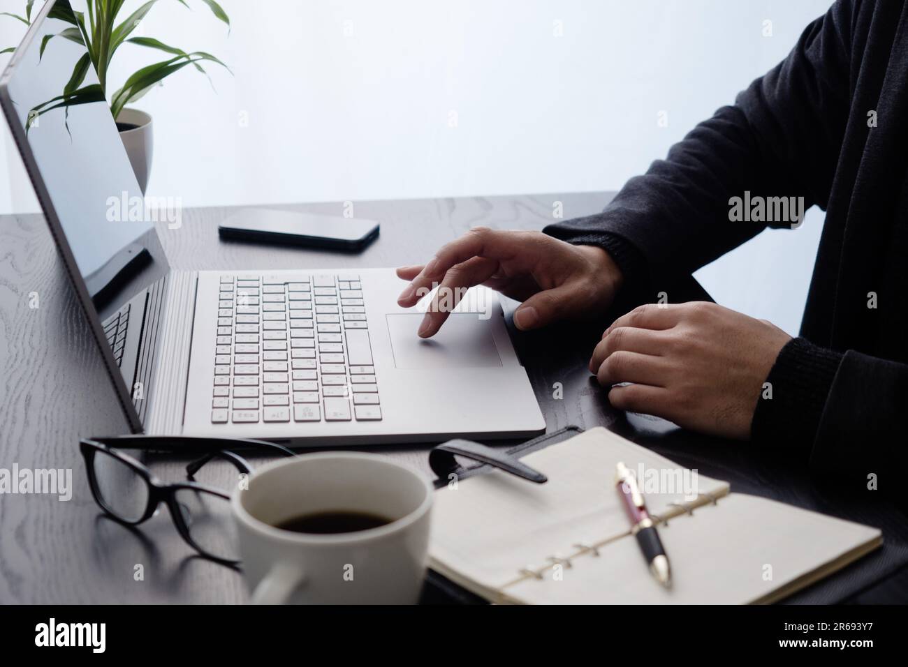 Japanese man at hand operating a computer Stock Photo - Alamy