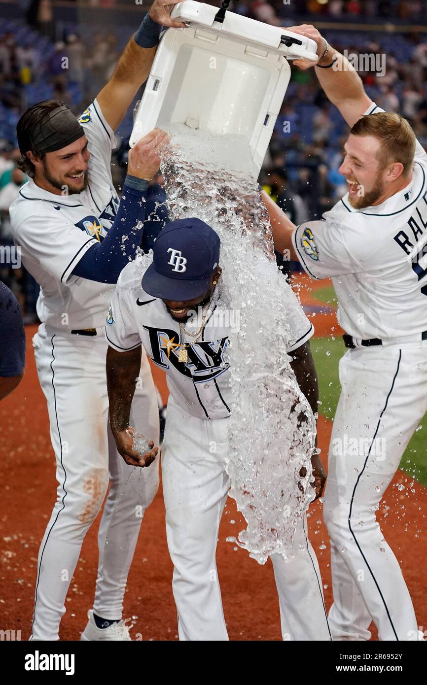 Tampa Bay Rays' Randy Arozarena, center, gets doused with ice water by Josh Lowe, left, and Luke ...