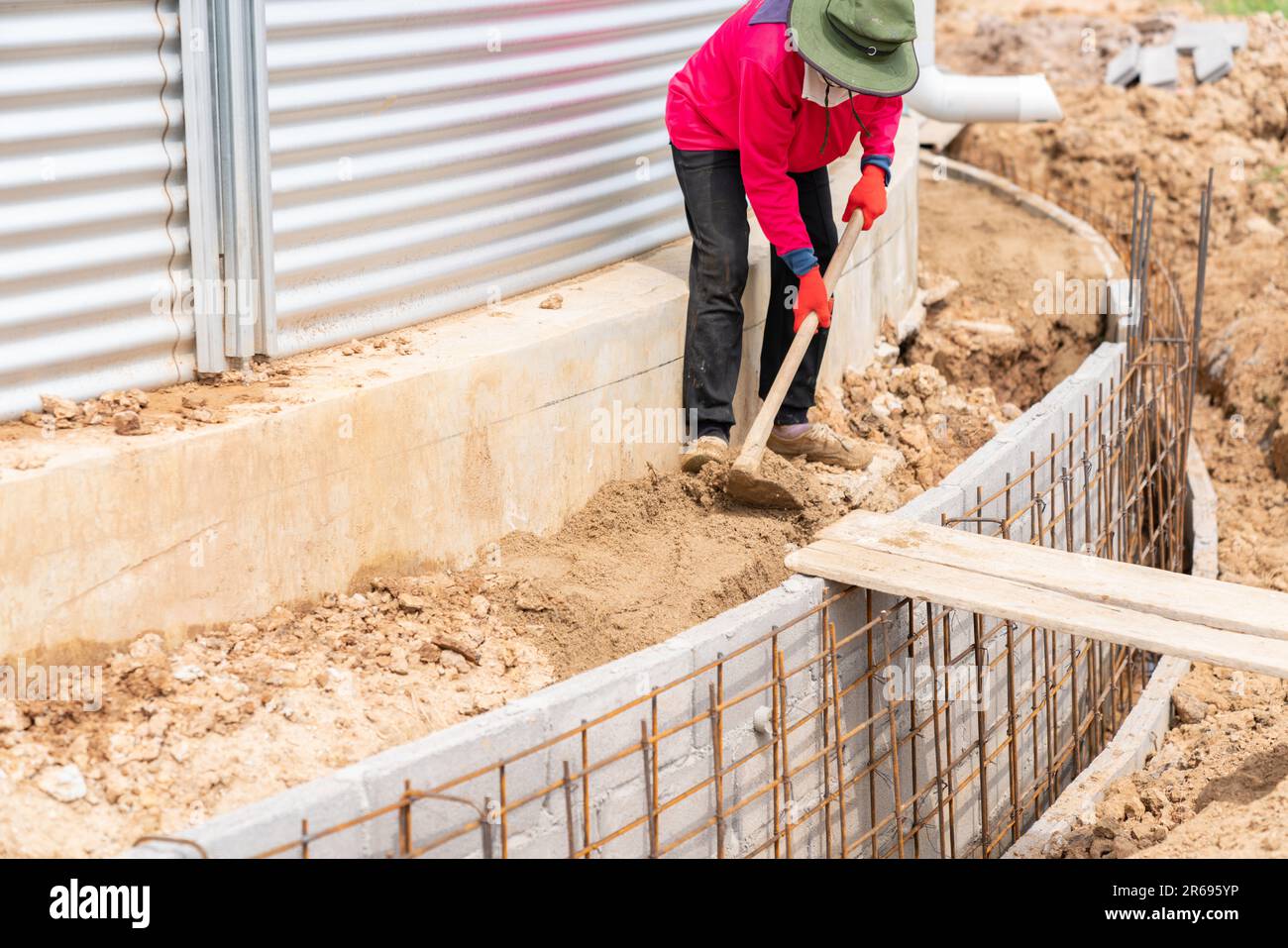 Worker is leveling the ground with a shovel in construction site Stock ...