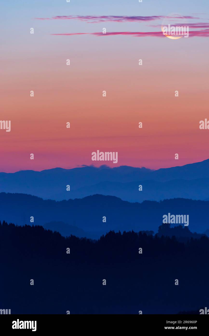 Mountain range and crescent moon at dawn Stock Photo - Alamy