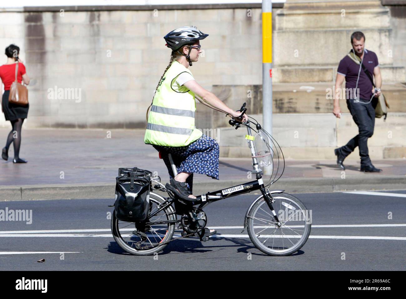 A cyclist with a bike bearing the 'One Less Car' slogan on Macquarie ...
