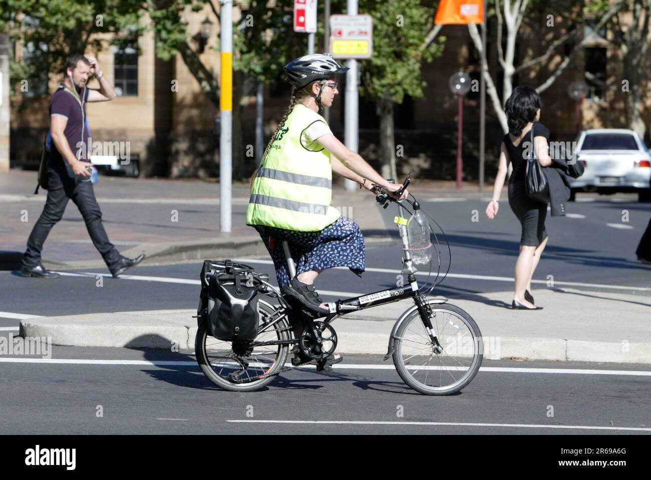 A cyclist with a bike bearing the 'One Less Car' slogan on Macquarie ...