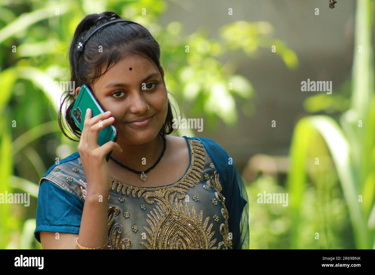 Indian Girl taking on mobile phone Stock Photo - Alamy