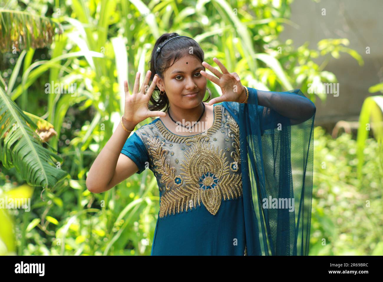 Indian Teenage Girl showing and pointing with finger number nine while ... Indian Teenage Girl showing and pointing with finger number nine while ...
