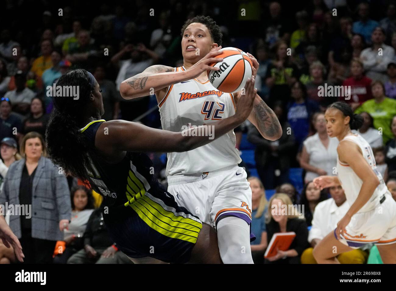 Dallas Wings center Kalani Brown, left, falls backward while defending ...