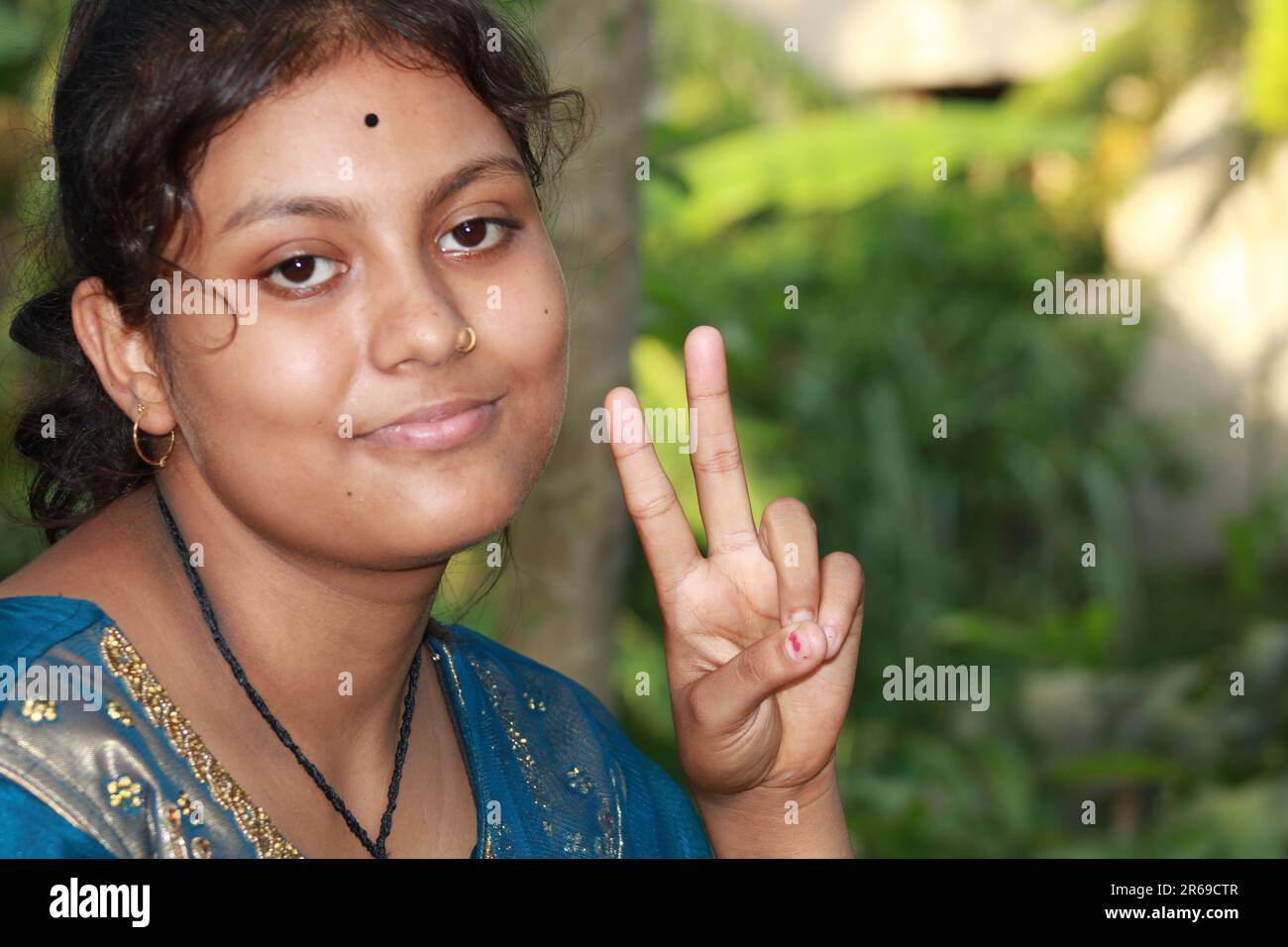 Portrait Of Beautiful Happy Indian Teenage Girl showing and pointing ...