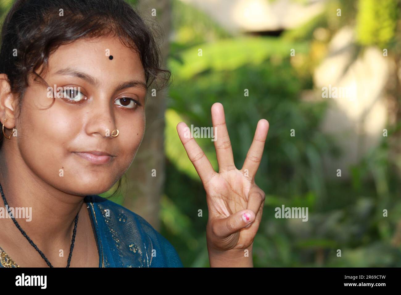 Portrait Of Beautiful Happy Indian Teenage Girl showing and pointing ... Portrait Of Beautiful Happy Indian Teenage Girl showing and pointing ...