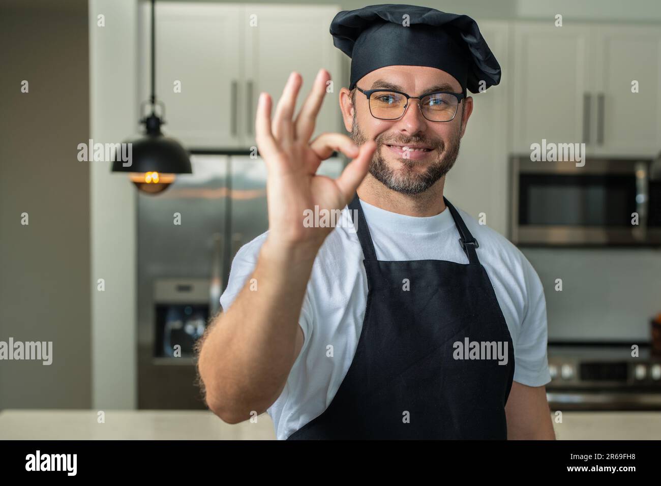 Man in chef apron cooking on kitchen Stock Photo - Alamy