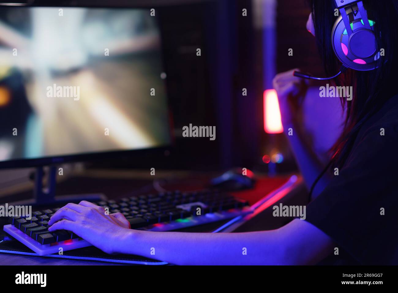 Female cyber hacker gamer watching monitor and making win gesture after ...