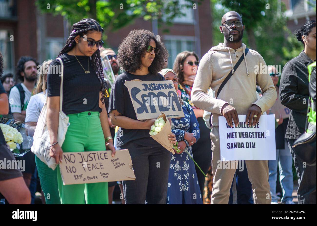 Protesters hold placards during the Sanda Dia protest Black Lives ...