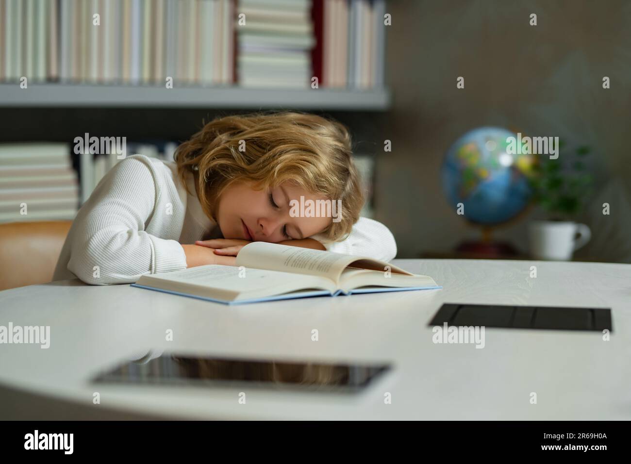 Tired school boy, bored pupil at school Stock Photo - Alamy