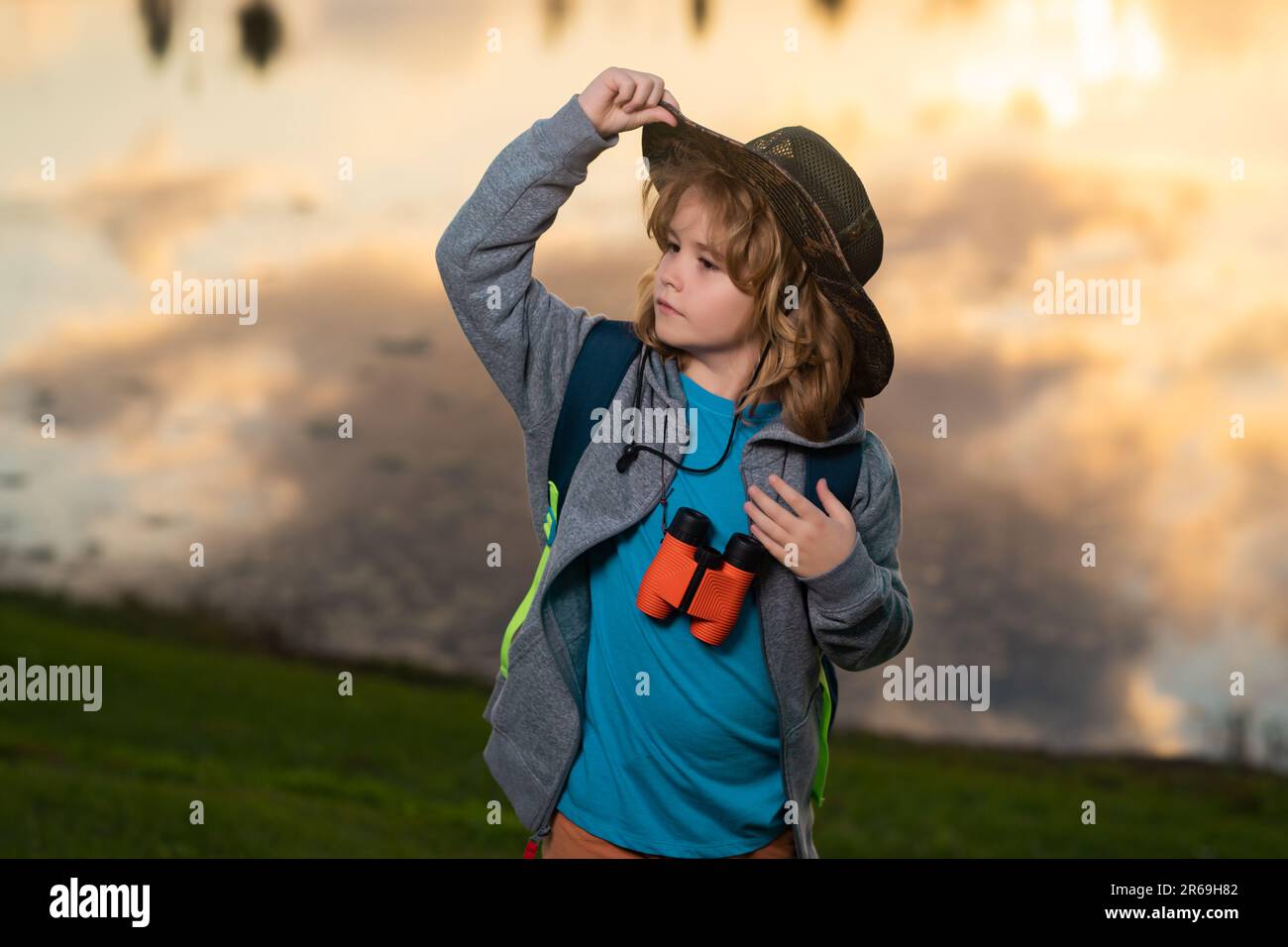 Scout boy wearing explorer hat and backpack outdoor. Explorer and adventure with binocular Stock ...