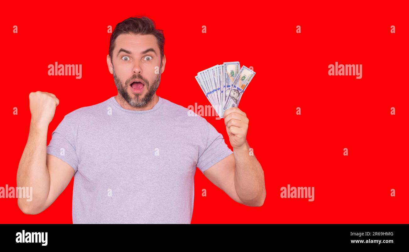 Portrait business man holding cash dollar bills over red studio ...