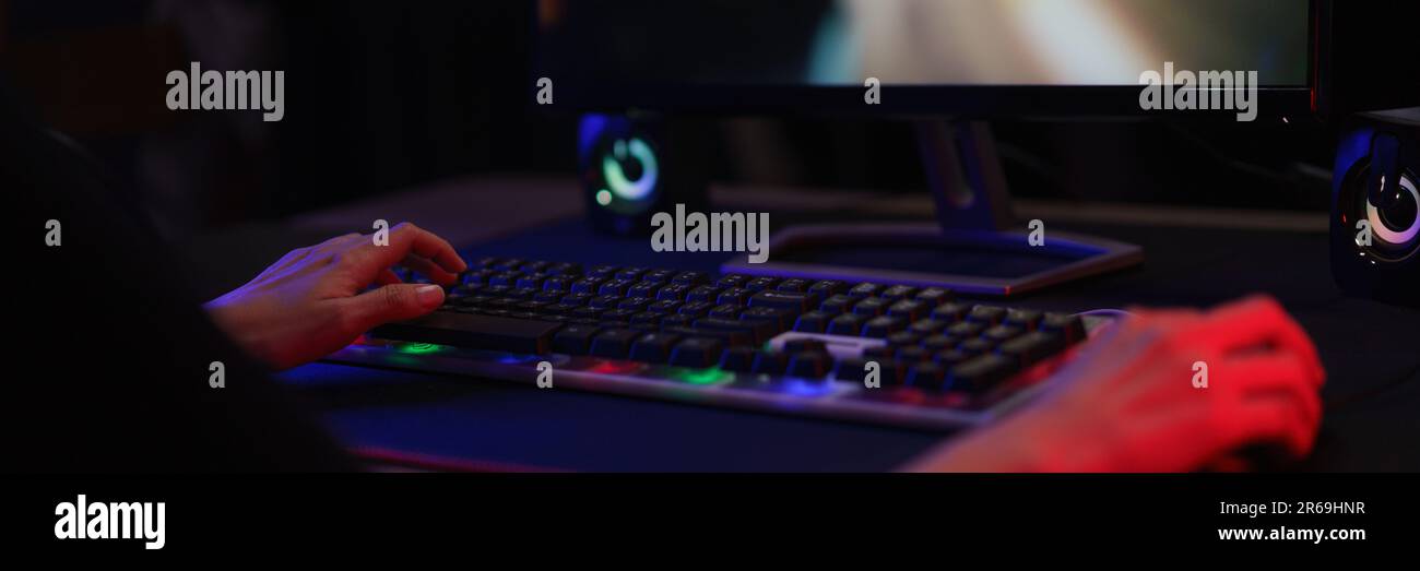 Female cyber hacker gamer using keyboard and mouse to playing games or ...