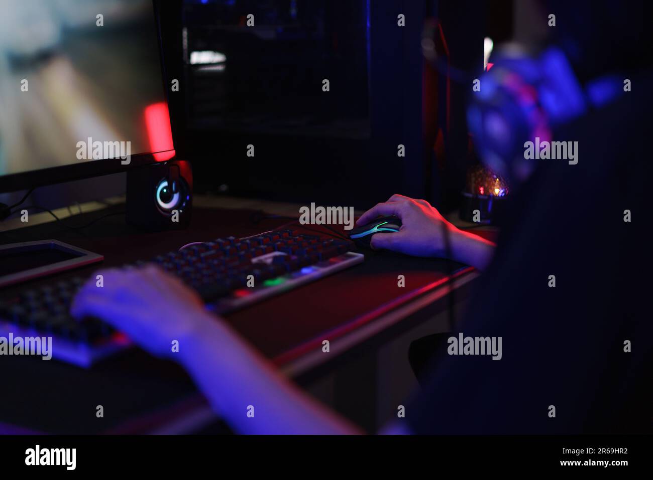 Female cyber hacker gamer using keyboard and mouse to playing games or ...