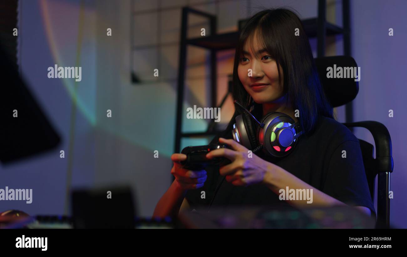 Female cyber hacker gamer using controller joystick to playing or ...