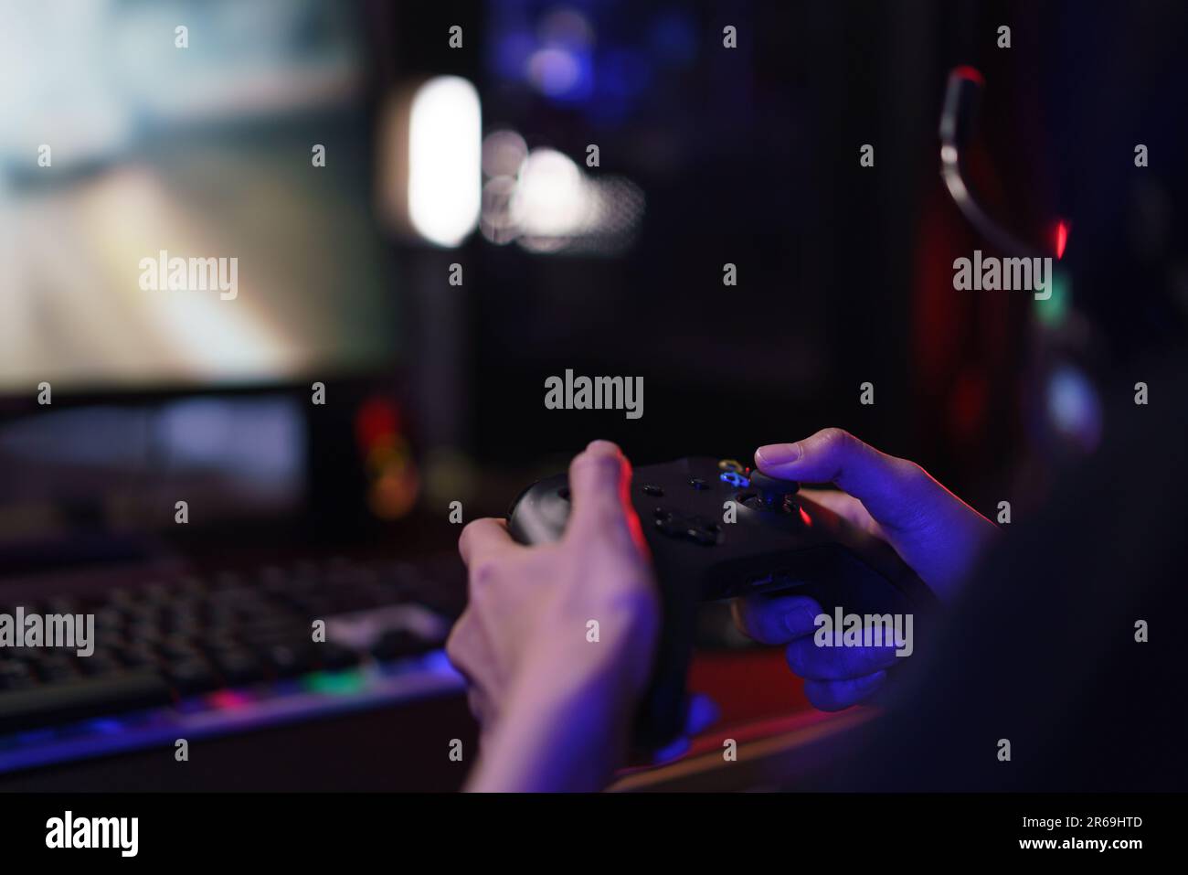 Hand of female cyber hacker gamer holding controller joystick to ...