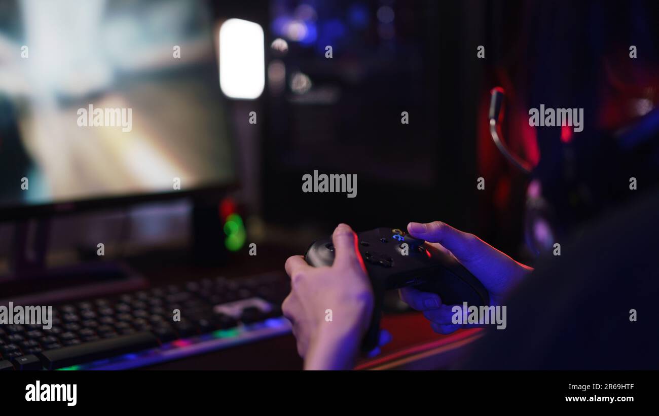 Hand of female cyber hacker gamer holding controller joystick to ...