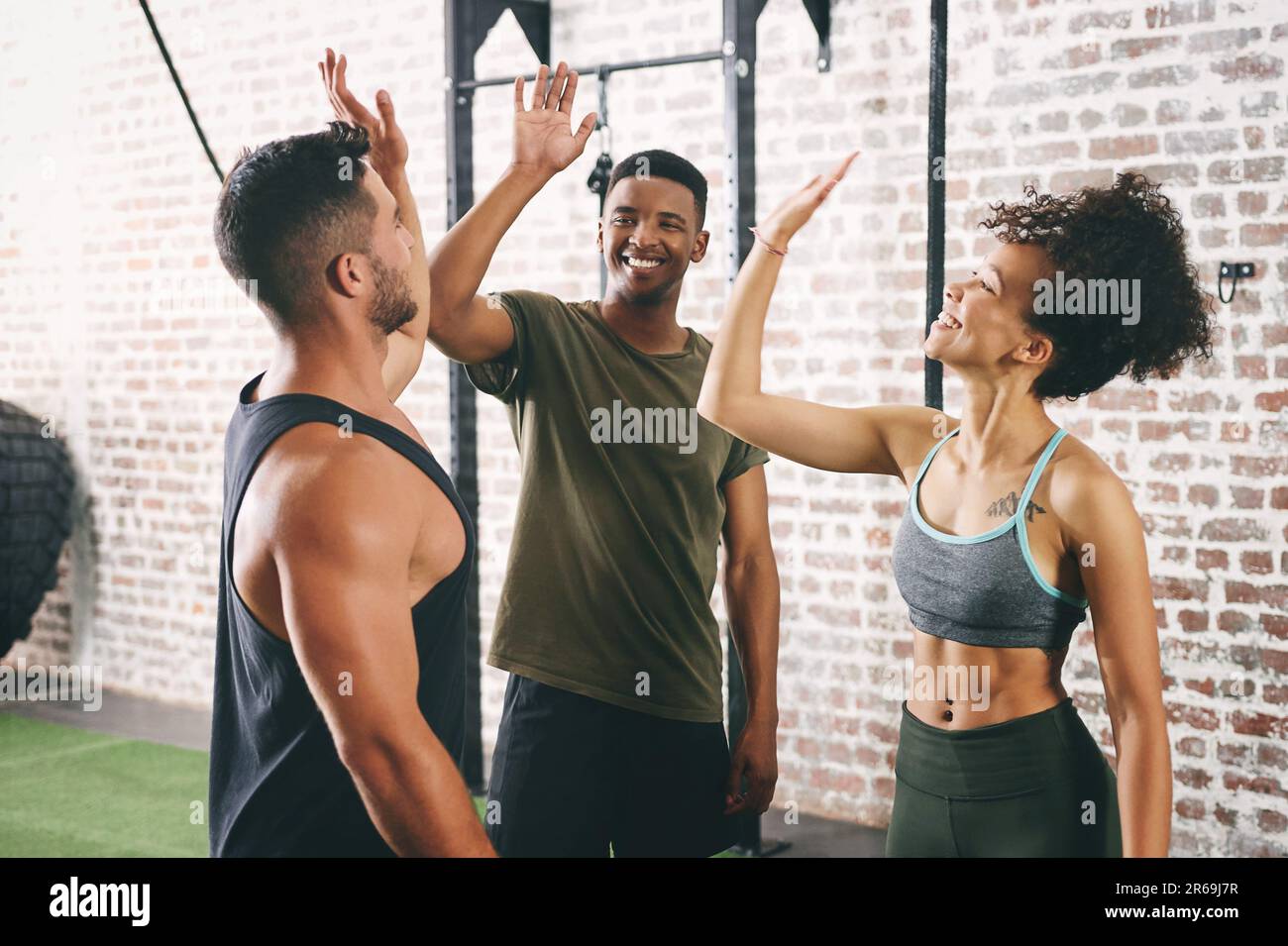 We sweat together and celebrate together. three sporty young people ...