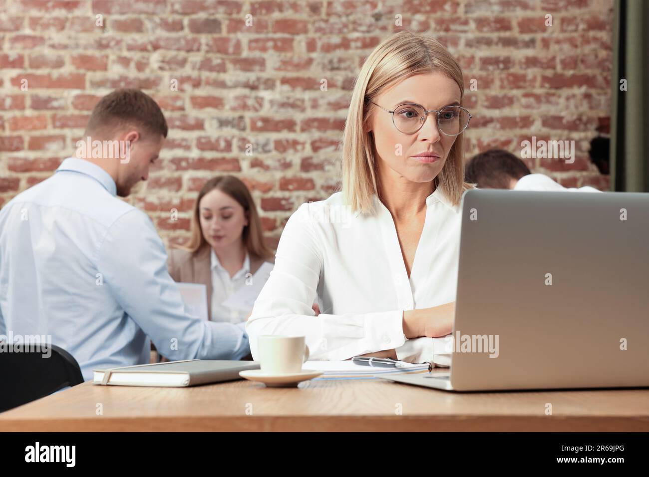 Businesswoman and her employees in office. Lady boss Stock Photo - Alamy