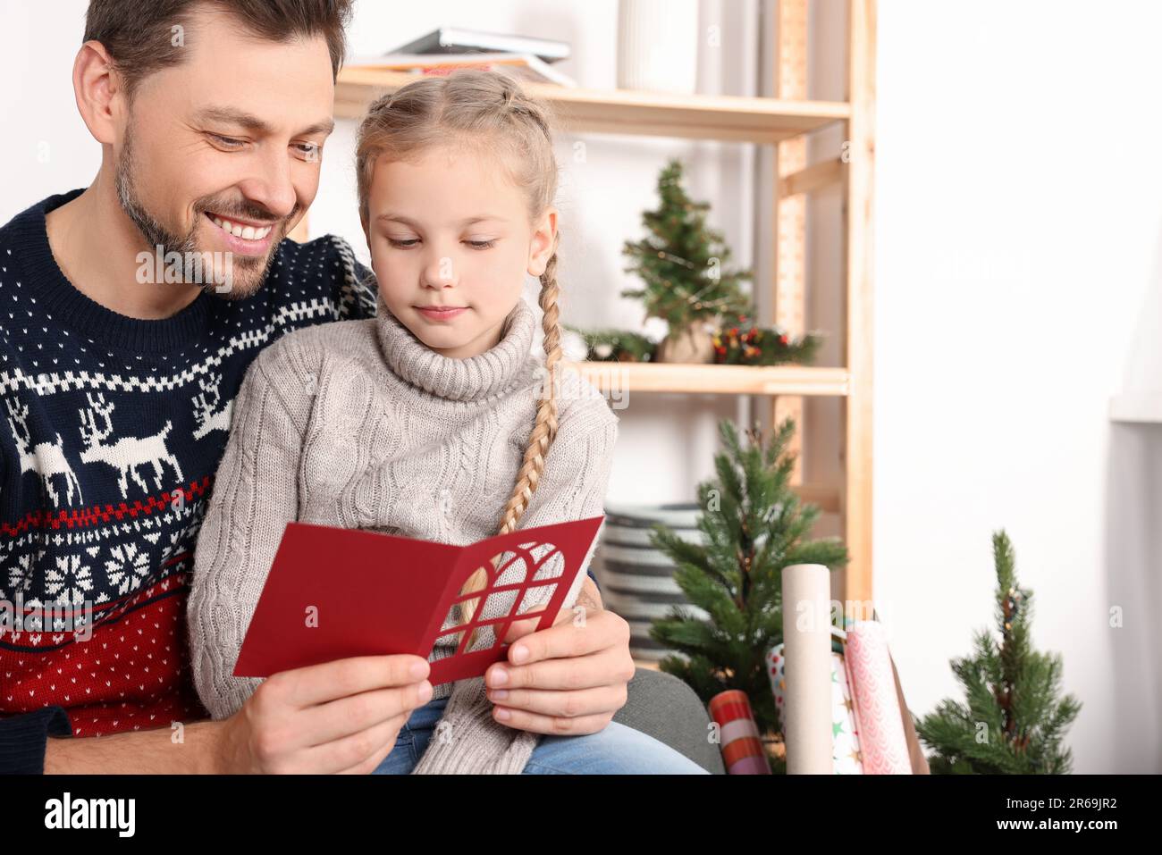 Happy man receiving greeting card from his daughter at home Stock Photo ...