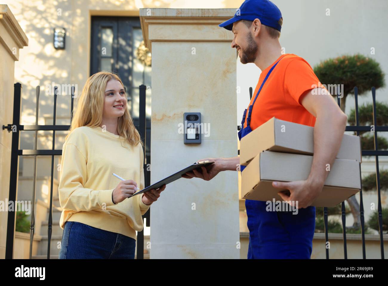 Woman signing receipt delivery hi-res stock photography and images - Alamy