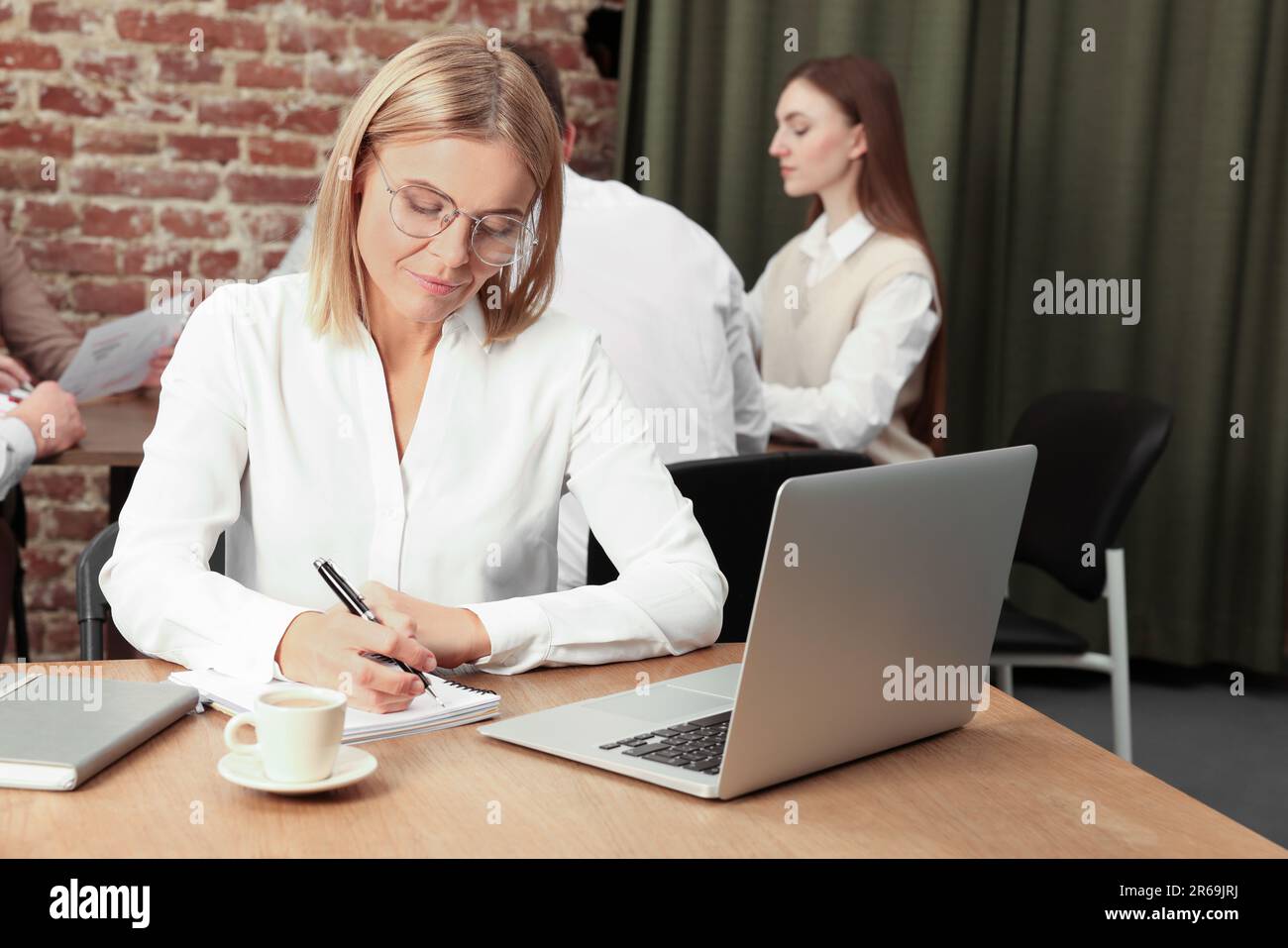 Businesswoman and her employees in office. Lady boss Stock Photo - Alamy