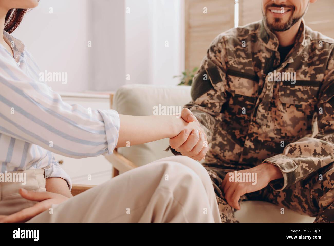 Psychologist shaking hands with military officer indoors, closeup Stock ...