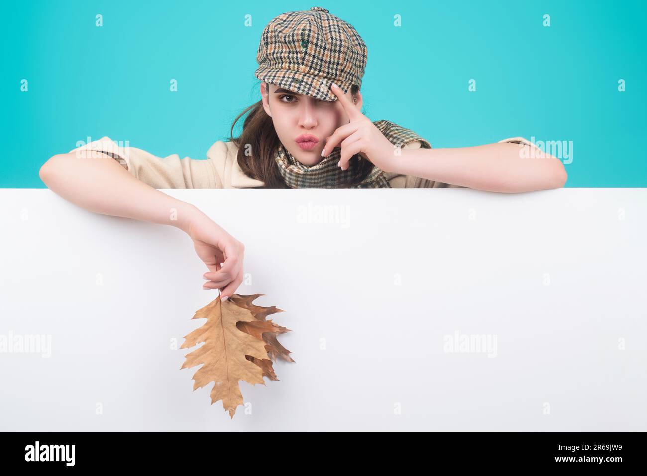 Studio portrait of young woman with autumn fall leaves Stock Photo - Alamy