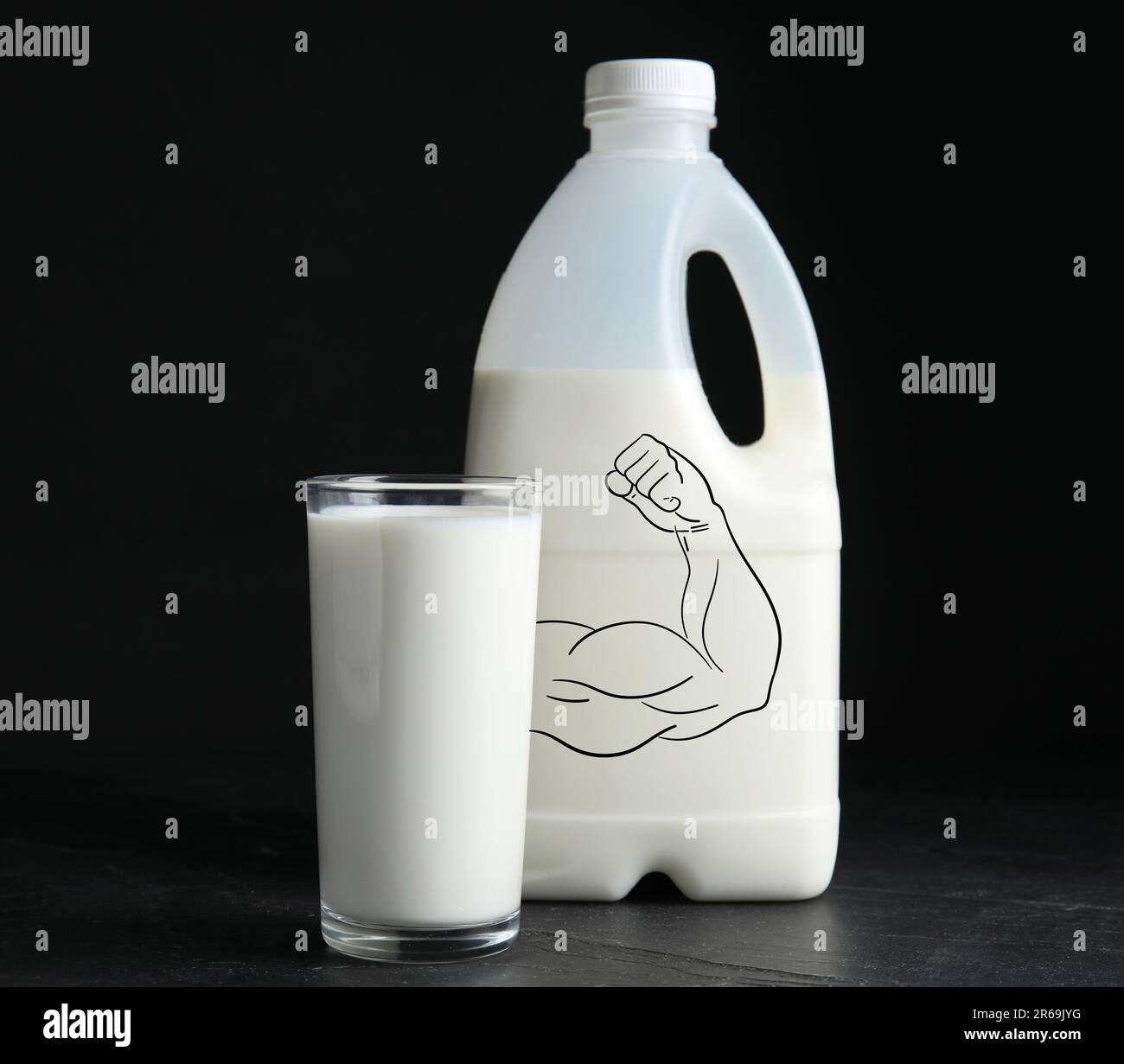 Gallon bottle and glass of milk on black table. Container with ...