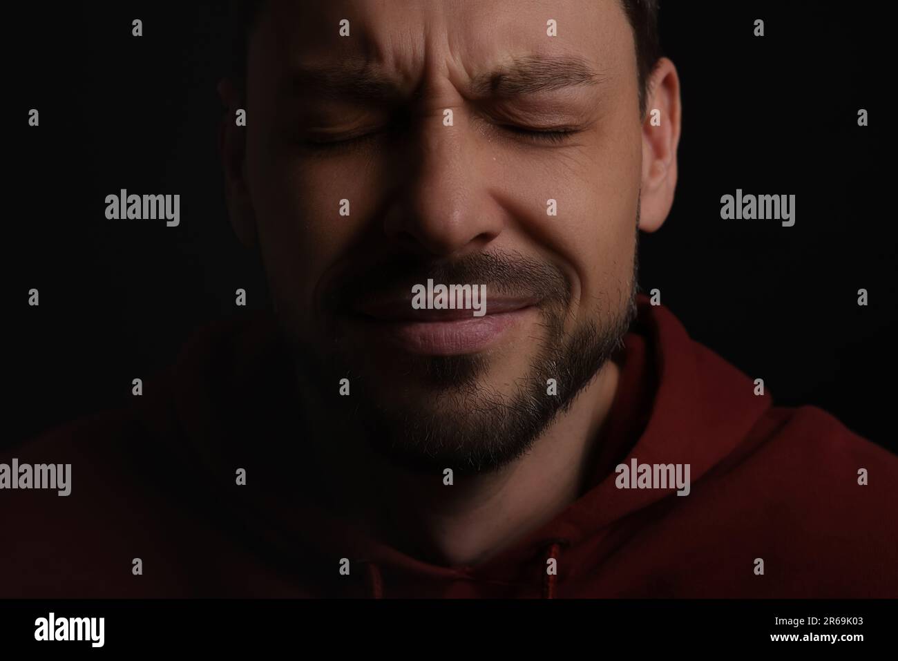 Sad man crying on black background, closeup Stock Photo - Alamy