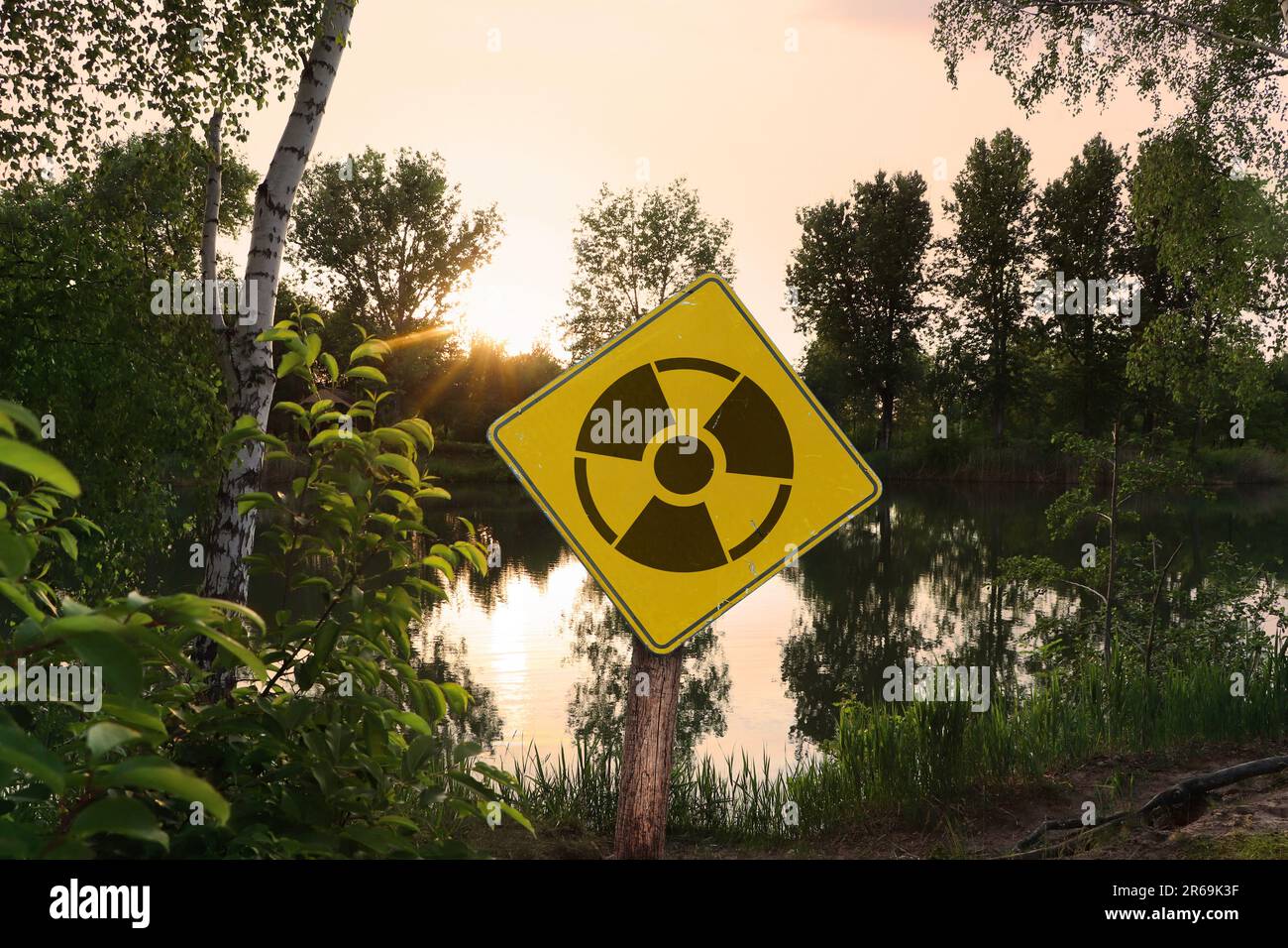 Radioactive pollution. Yellow warning sign with hazard symbol near ...