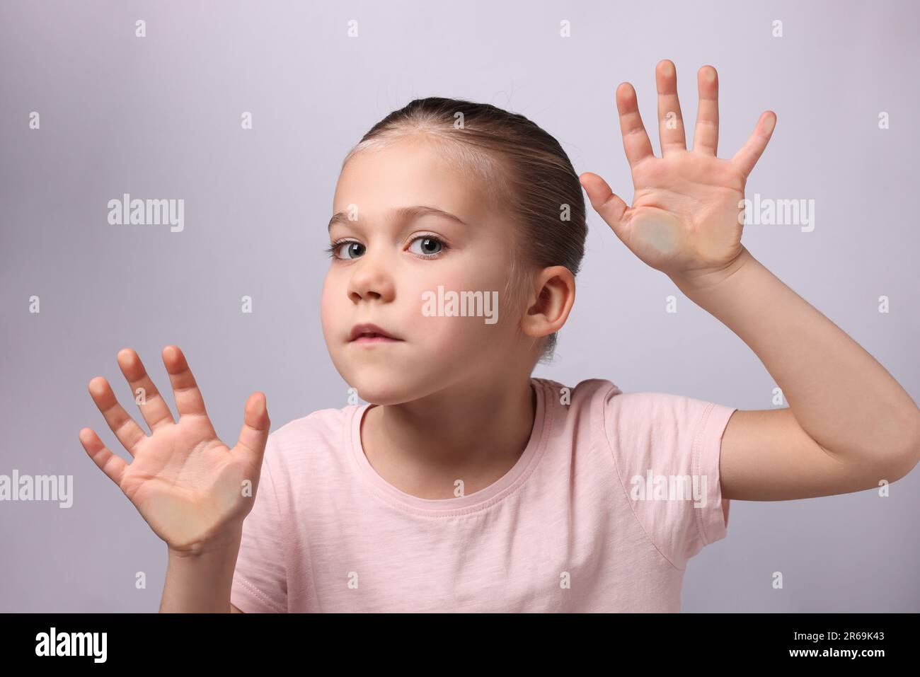 Cute little girl stuck to transparent screen Stock Photo - Alamy