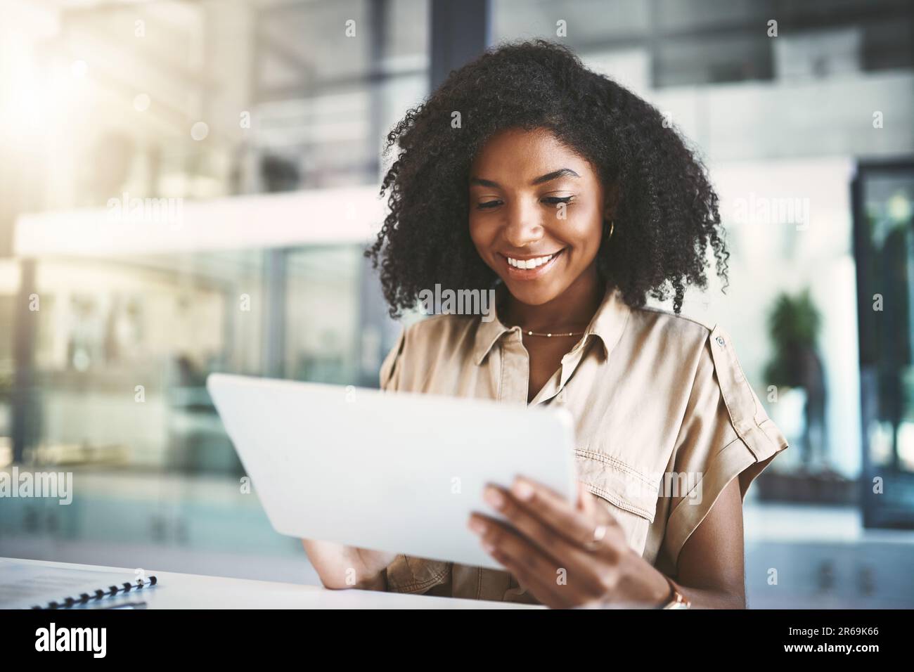 Productivity at the tap of an icon. a young businesswoman using a ...