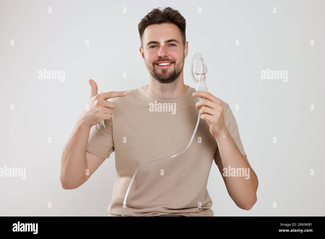 Man holding nebulizer for inhalation on beige background Stock Photo ...